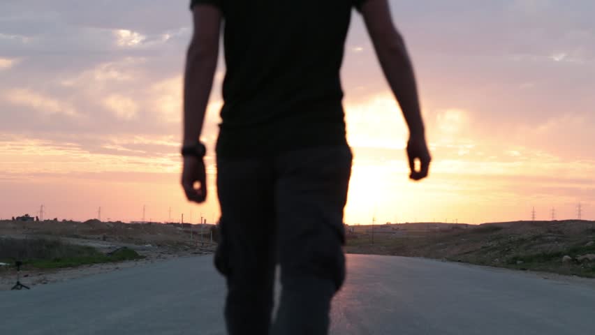 man walking down road into sunset Stock Footage Video (100% Royalty ...
