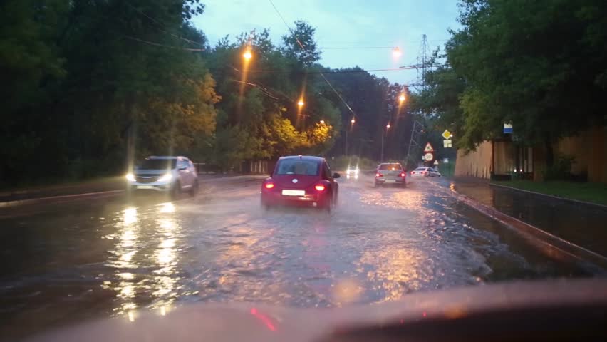 cars driving through puddle along streets Stock Footage Video (100% ...