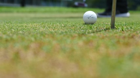 slow motion golf ball falls into Stock Footage Video (100% Royalty-free ...