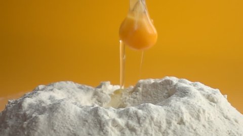 Egg Dropping Into Flour On Yellow Stock Footage Video (100% Royalty ...