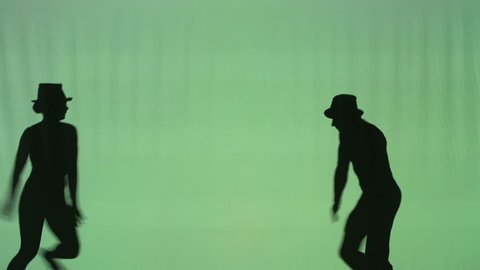 woman's silhouette dancing against green background Stock Footage Video ...