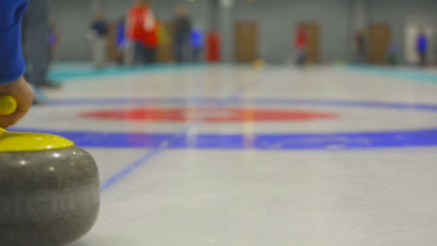 curling player delivering stone on rink Stock Footage Video (100% ...