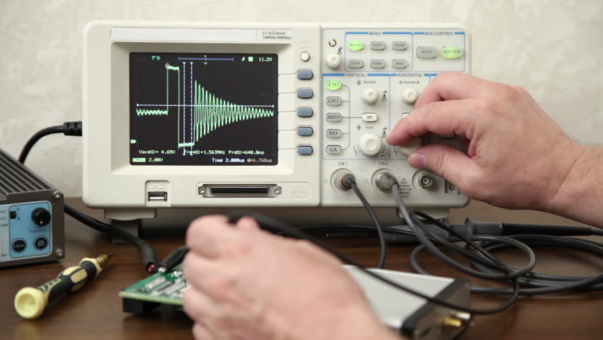 engineer's hand turns oscilloscope handle measuring Stock Footage Video ...