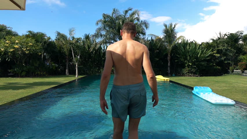 young man walking into swimming pool Stock Footage Video (100% Royalty ...