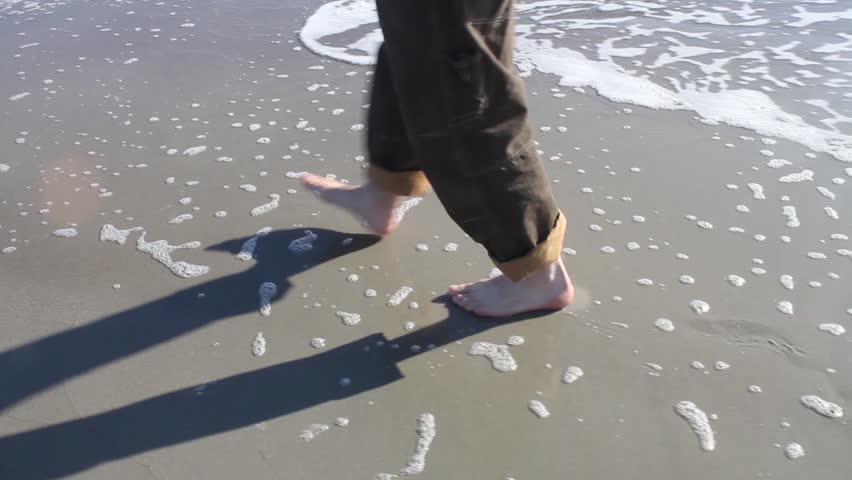 man walking slowly along surf on Stock Footage Video (100% Royalty-free ...