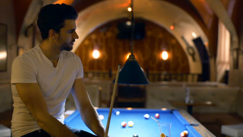 handsome man sitting on billiard's table Stock Footage Video (100% ...