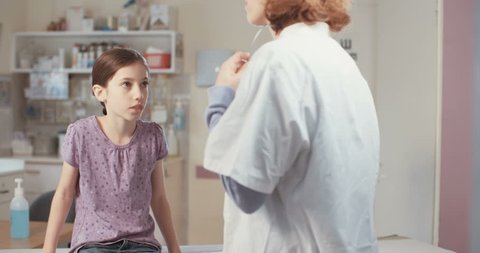 Female Doctor Performing Inspection On Girl Stock Footage Video (100% ...