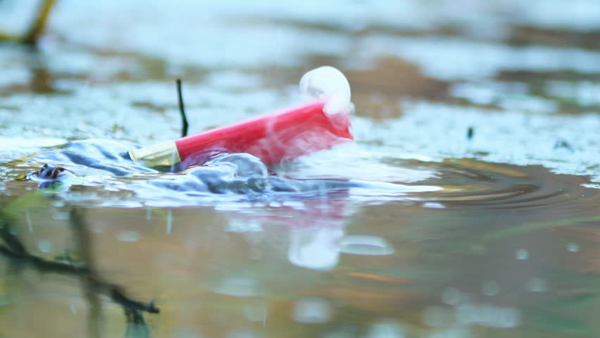 shotgun shell falling water smoke coming Stock Footage Video (100% ...