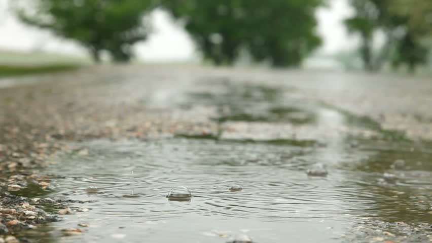 raindrops road puddle surface level Stock Footage Video (100% Royalty ...
