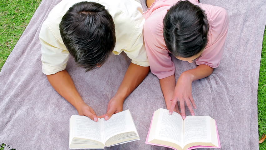 smiling couple reading books while lying Stock Footage Video (100% ...