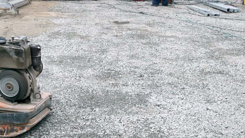 vibrating machine compacting gravel soil construction Stock Footage ...