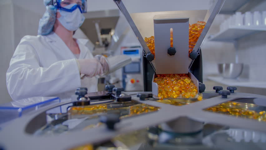 pharmaceutical factory worker putting yellow pills Stock Footage Video ...
