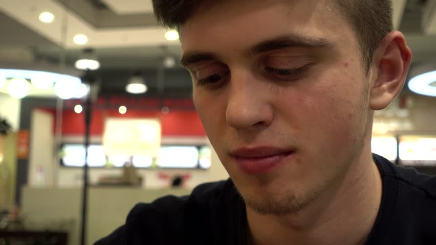 young man eating kebab sitting on Stock Footage Video (100% Royalty ...