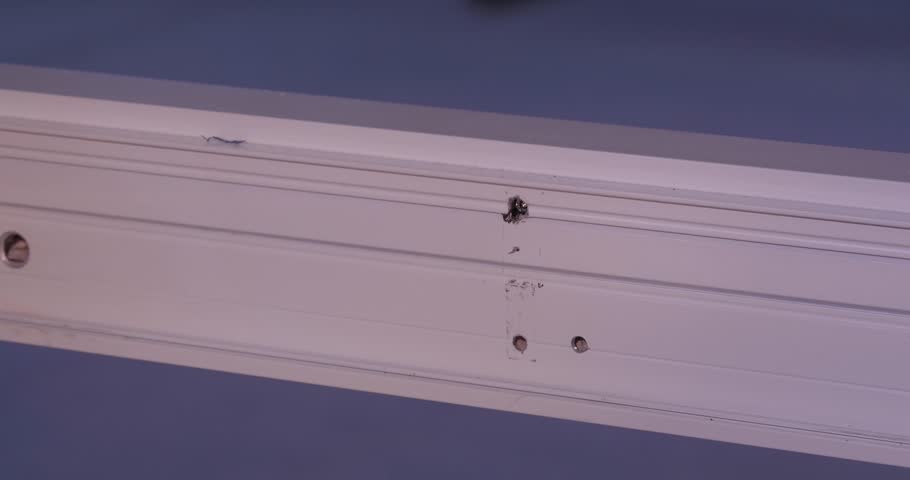 Production and manufacturing of pvc windows, a male worker assembles a ...