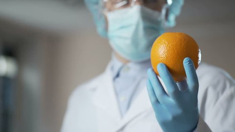 Doctor Injecting Serum Into Orange Showing Stock Footage Video (100% ...