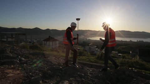 Two Surveyor Helmets Performing Geodesic Measurements Stock Footage ...