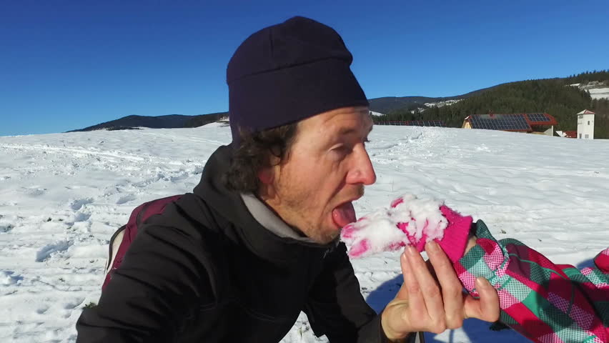 man eating snow out daughter's hand Stock Footage Video (100% Royalty ...