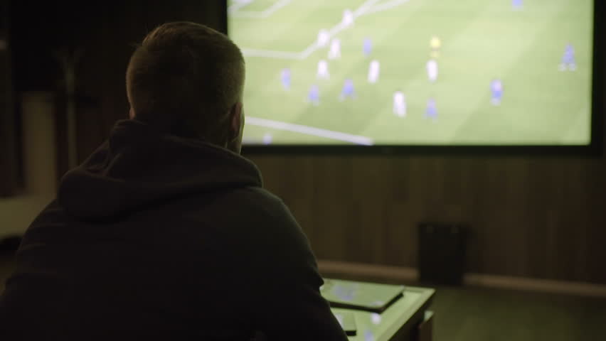 man watching football on big screen Stock Footage Video (100% Royalty ...
