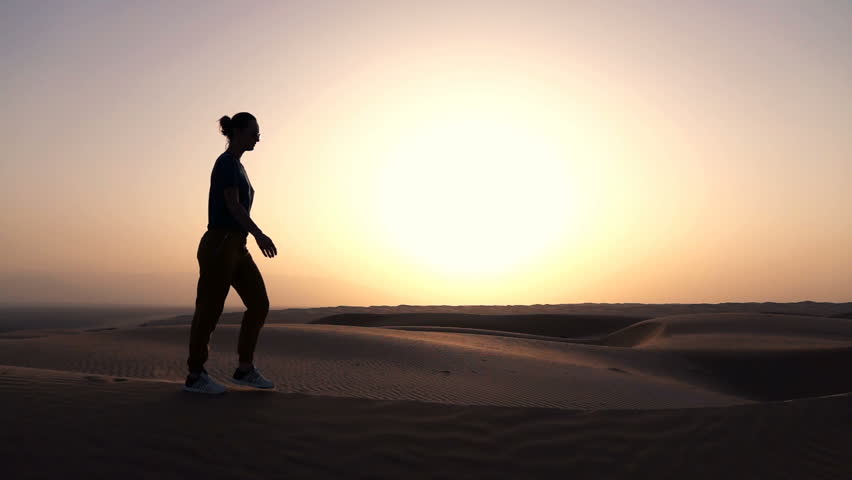 silhouette woman walking on desert during Stock Footage Video (100% ...