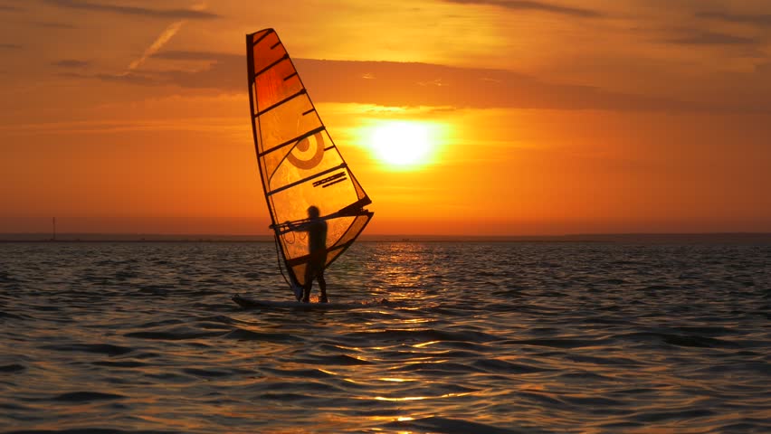 windsurfing rippling sea sunset windsurfer surfing Stock-video (100 % ...