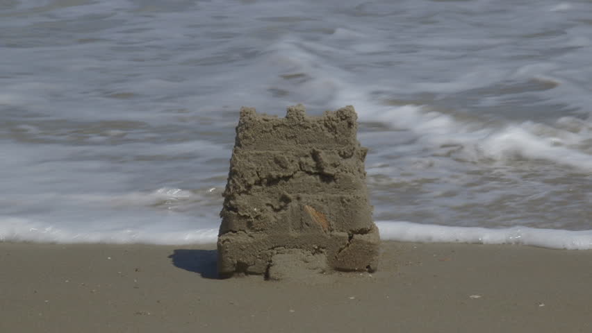 ocean waves destroying sandcastle on beach Stock Footage Video (100% ...