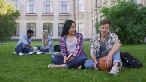 Students Sitting On Lawn On Campus Stock Footage Video (100% Royalty ...
