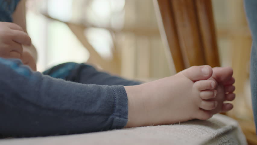 toddler's toes wiggle while sitting on Stock Footage Video (100% ...