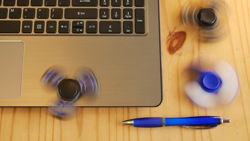 Spinners Spinning Next to Laptop Stock Footage Video (100% Royalty-free ...
