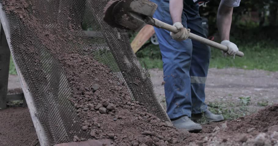Construction Worker Sifting Gravel Through Sieve Stock Footage Video ...