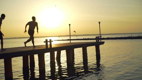 Silhouette Friends Running Jumping Off Sea Stock Footage Video (100% ...