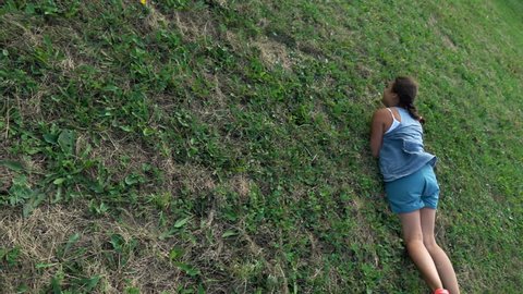 Happy Teenage Girl Rolling Down Hill Stock Footage Video (100% Royalty ...