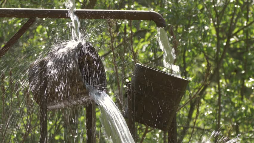 water falling out hanging buckets Stock Footage Video (100% Royalty ...