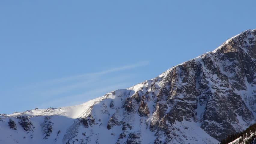pan desolate snow-covered mountain peaks montana Stock Footage Video ...