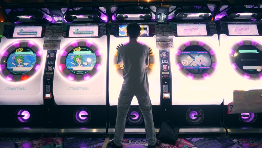 young asian man playing arcade machine Stock Footage Video (100% ...