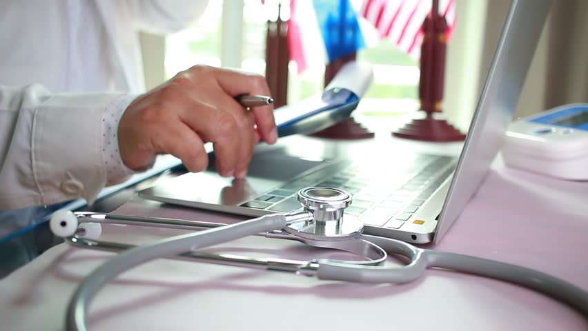 doctor's writing working on laptop computer Stock Footage Video (100% ...