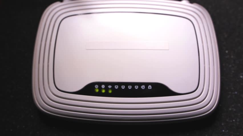 Macro of ADSL wifi router lights flashing on black background ...