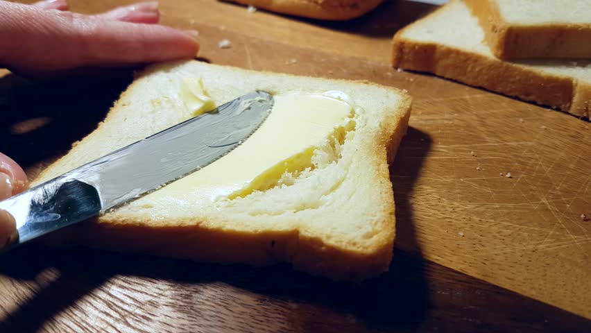 hands smear butter on bread Stock Footage Video (100% Royalty-free ...