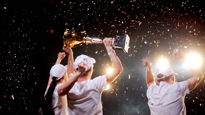 Team of four young winners together celebrates success and jump for joy ...