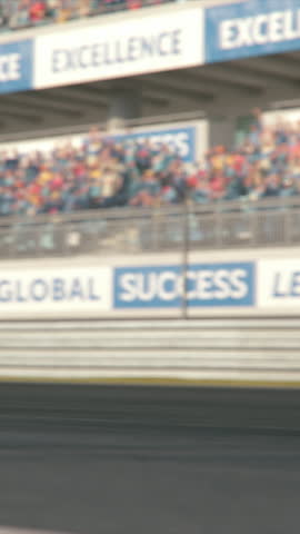 Side view of a generic race car driving across the finish line in slow ...