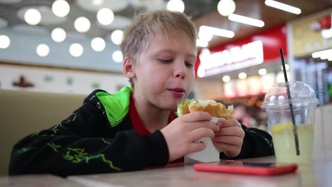 Child Eating Hamburger Fast Food Restaurant Stock Footage Video (100% ...