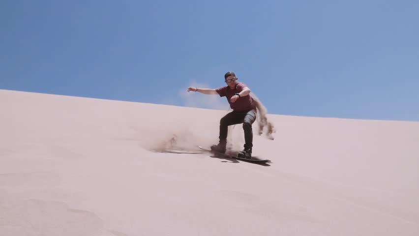man sandboarding great sand dunes dead Stock Footage Video (100% ...