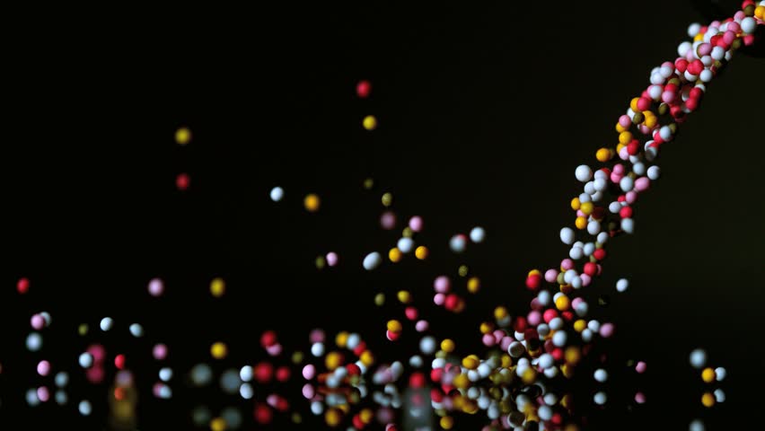sprinkles pouring onto black surface slow Stock Footage Video (100% ...