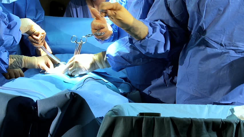 doctor wearing protective clothing performing surgery Stock Footage ...