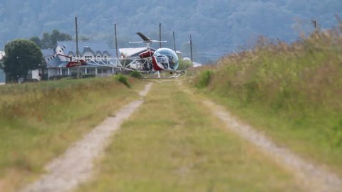 Small Two Person Helicopter Lands On Stock Footage Video (100% Royalty ...
