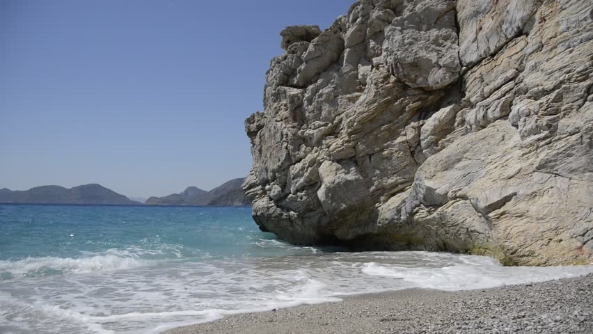waves crashing on rocky cliff pebble Stock Footage Video (100% Royalty ...