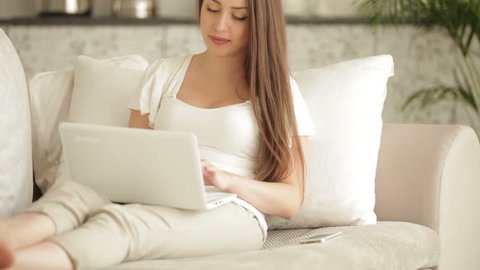 Pretty Young Woman Sitting On Sofa Stock Footage Video (100% Royalty ...