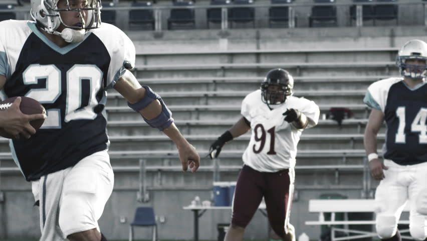 quarterback hikes ball hands off running Stock Footage Video (100% ...