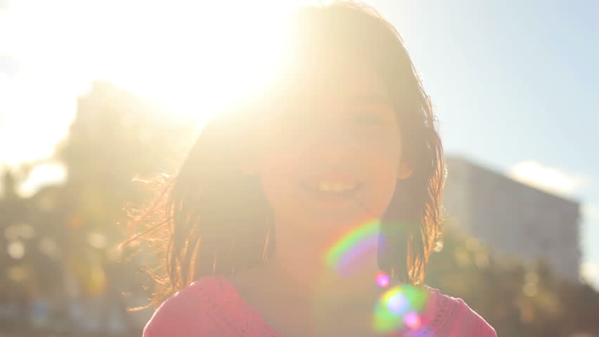 young girl smiles camera sun behind Stock Footage Video (100% Royalty ...