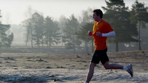 Jogger Running Through Park Slow Motion Stock Footage Video (100% ...