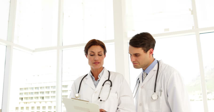 two doctors speaking about file hospital Stock Footage Video (100% ...